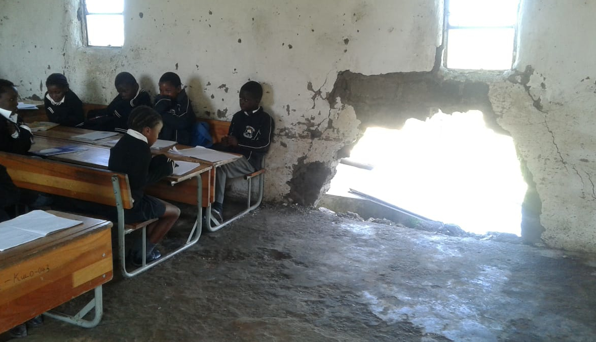 Mud classrooms crumble while building materials sit on site | GroundUp